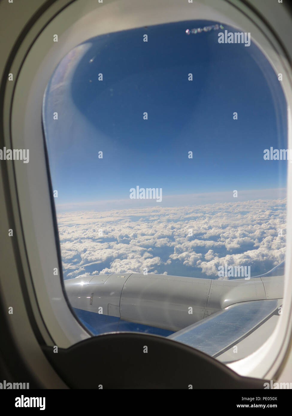 Blue sky and clouds through aircraft window Stock Photo - Alamy