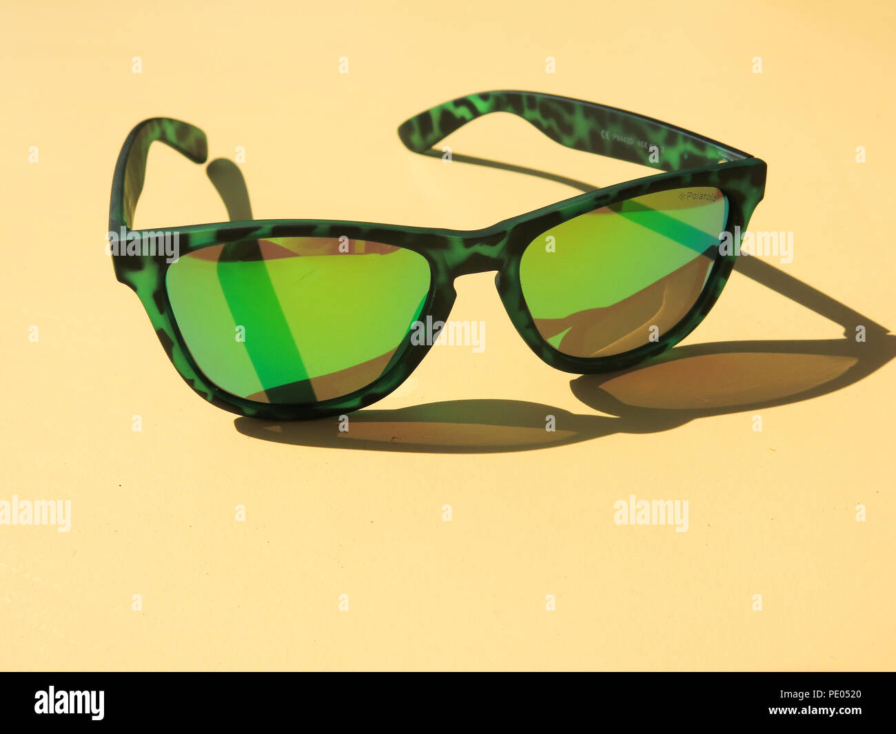 Sunglasses on table in sunshine Stock Photo - Alamy