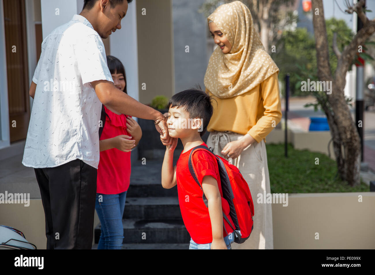 asian kid shake hand to parent before going to school in front of the ...