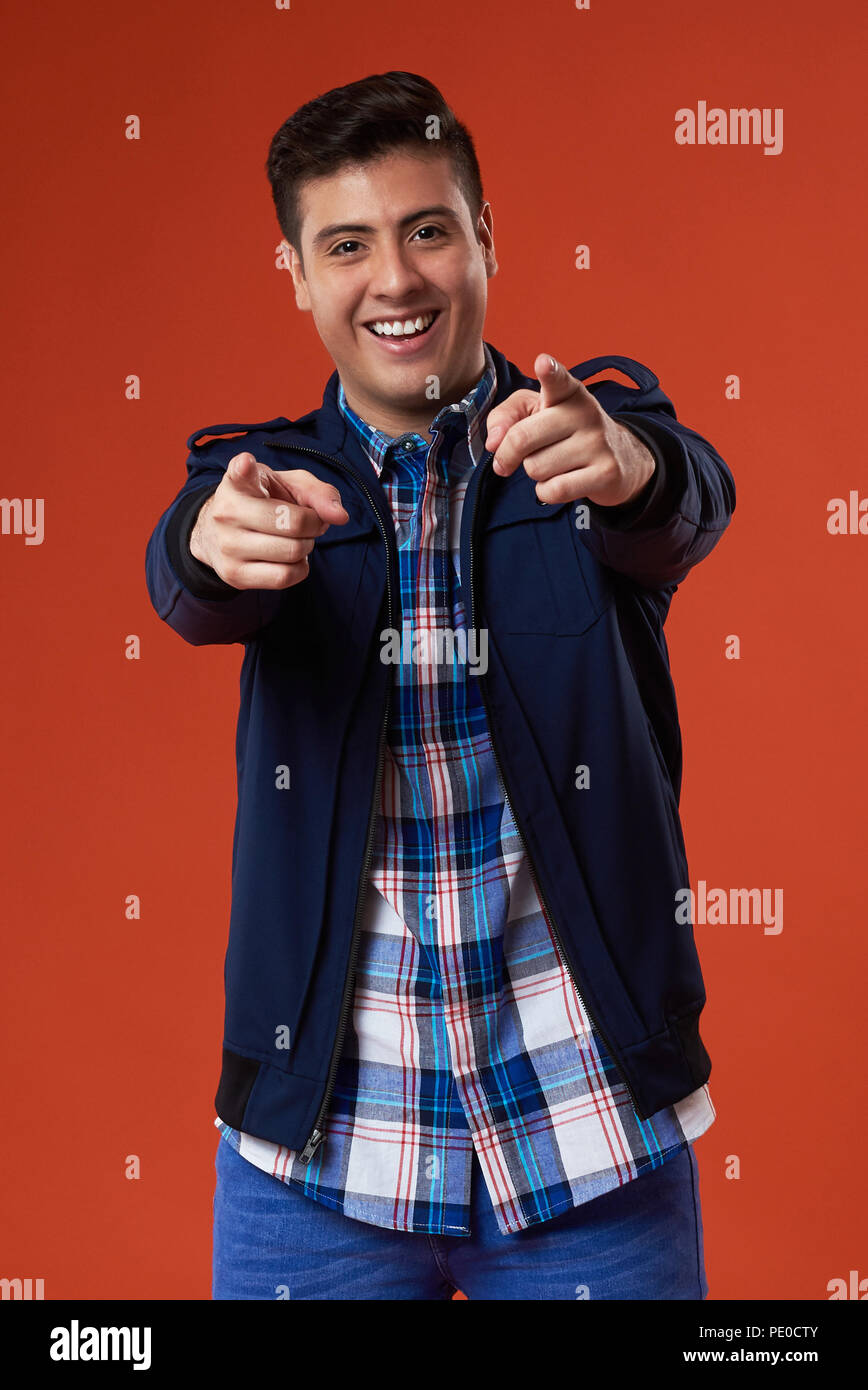 Smiling young guy pointing finger hi-res stock photography and images ...