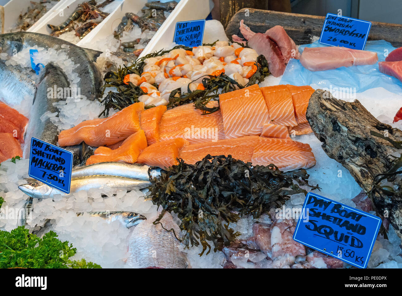 Salmon fillet and other fish and seafood for sale at a market in London ...