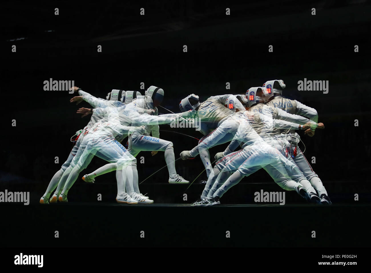 Russian fencer (L) attacks Great Britain fencer at the Men's team foil ...