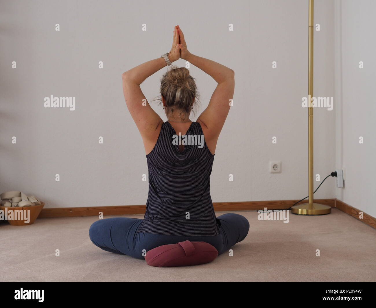 Woman from behind in a sitting yoga pose Stock Photo - Alamy