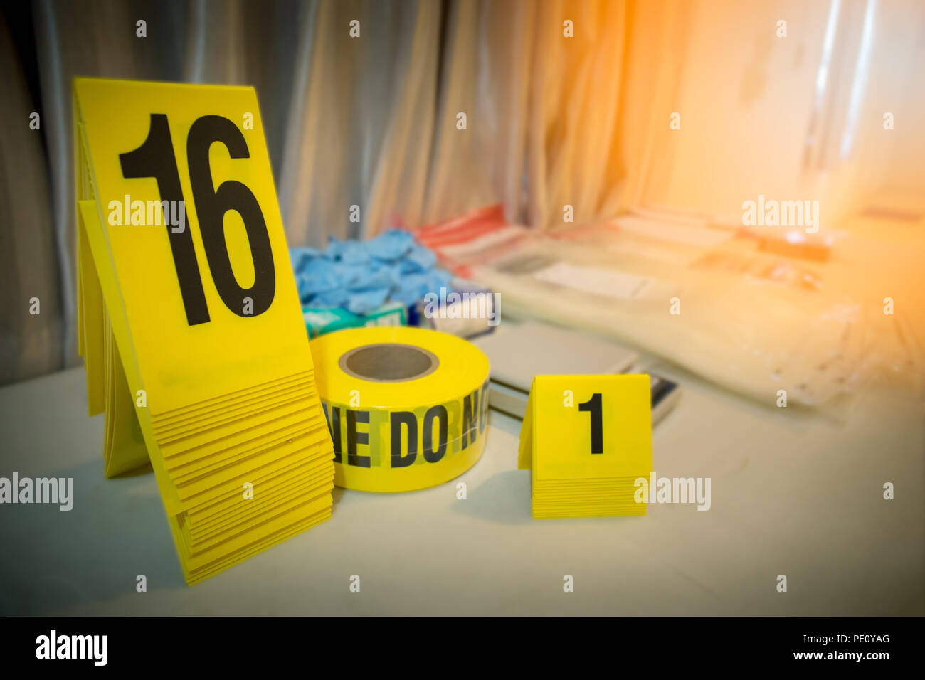 police line and evidence marker with forencsic science tool background ...