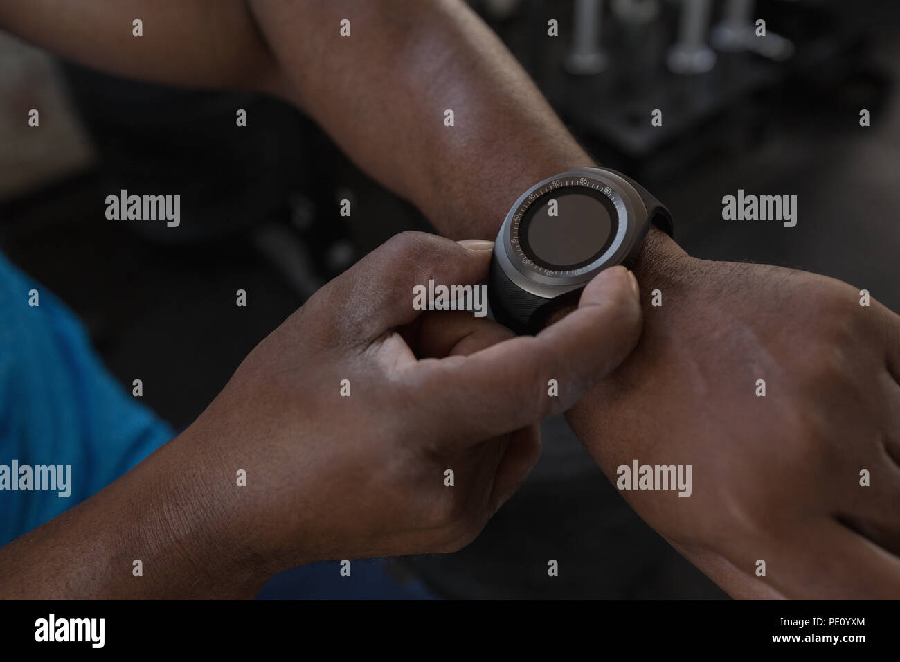 Man adjusting his smart watch Stock Photo - Alamy