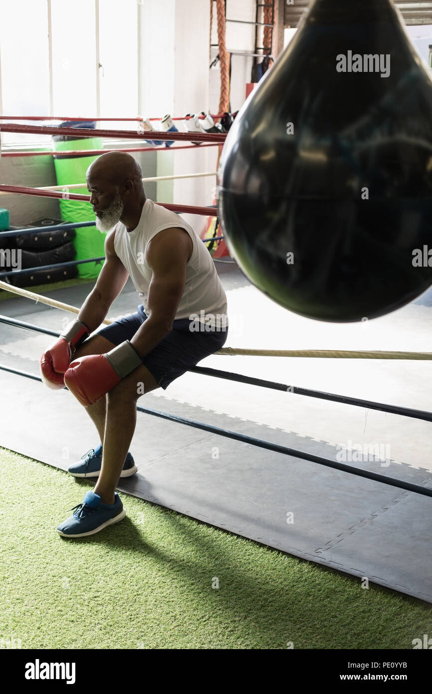 Senior man sitting on the boxing ring in fitness studio Stock Photo - Alamy