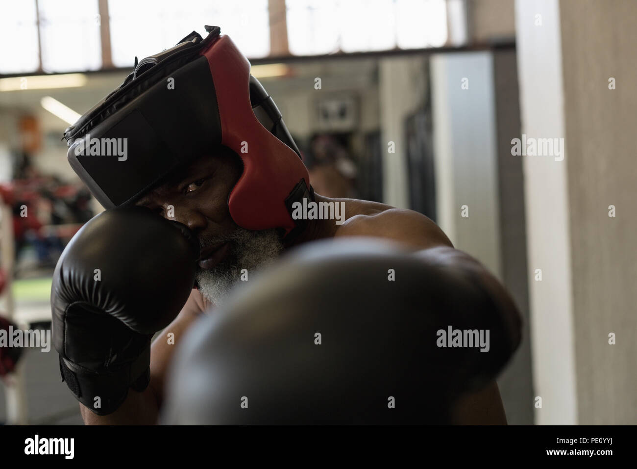 Senior man boxing in the fitness studio Stock Photo - Alamy