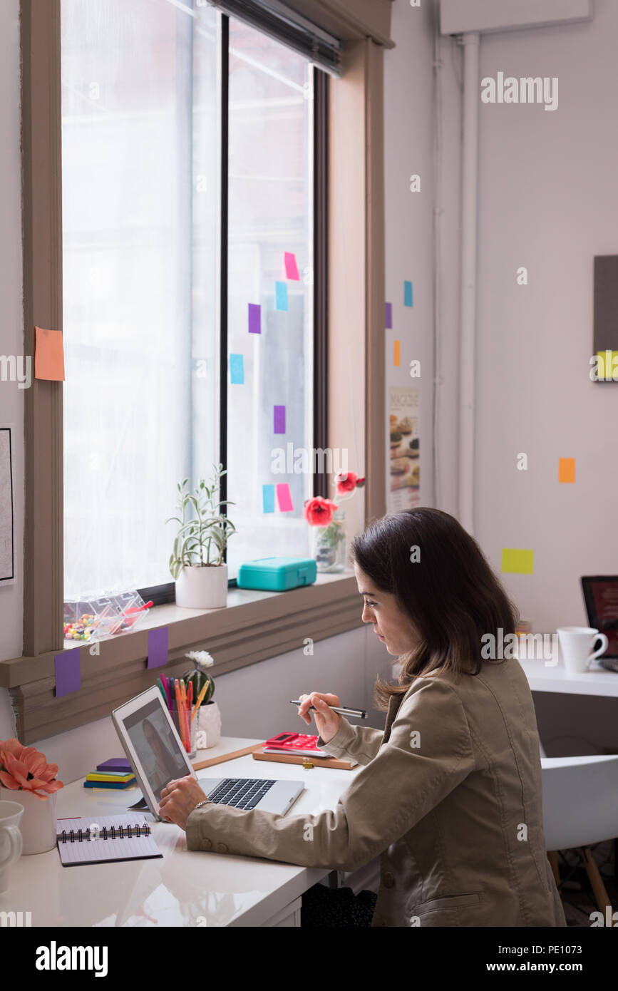 Fashion designers using laptop Stock Photo - Alamy