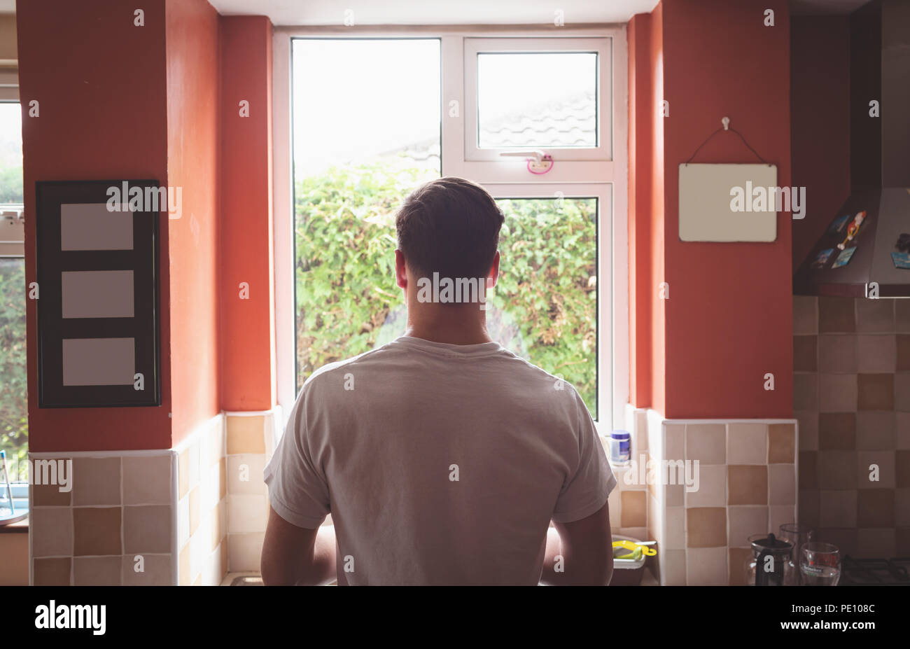 Man standing in the kitchen Stock Photo - Alamy