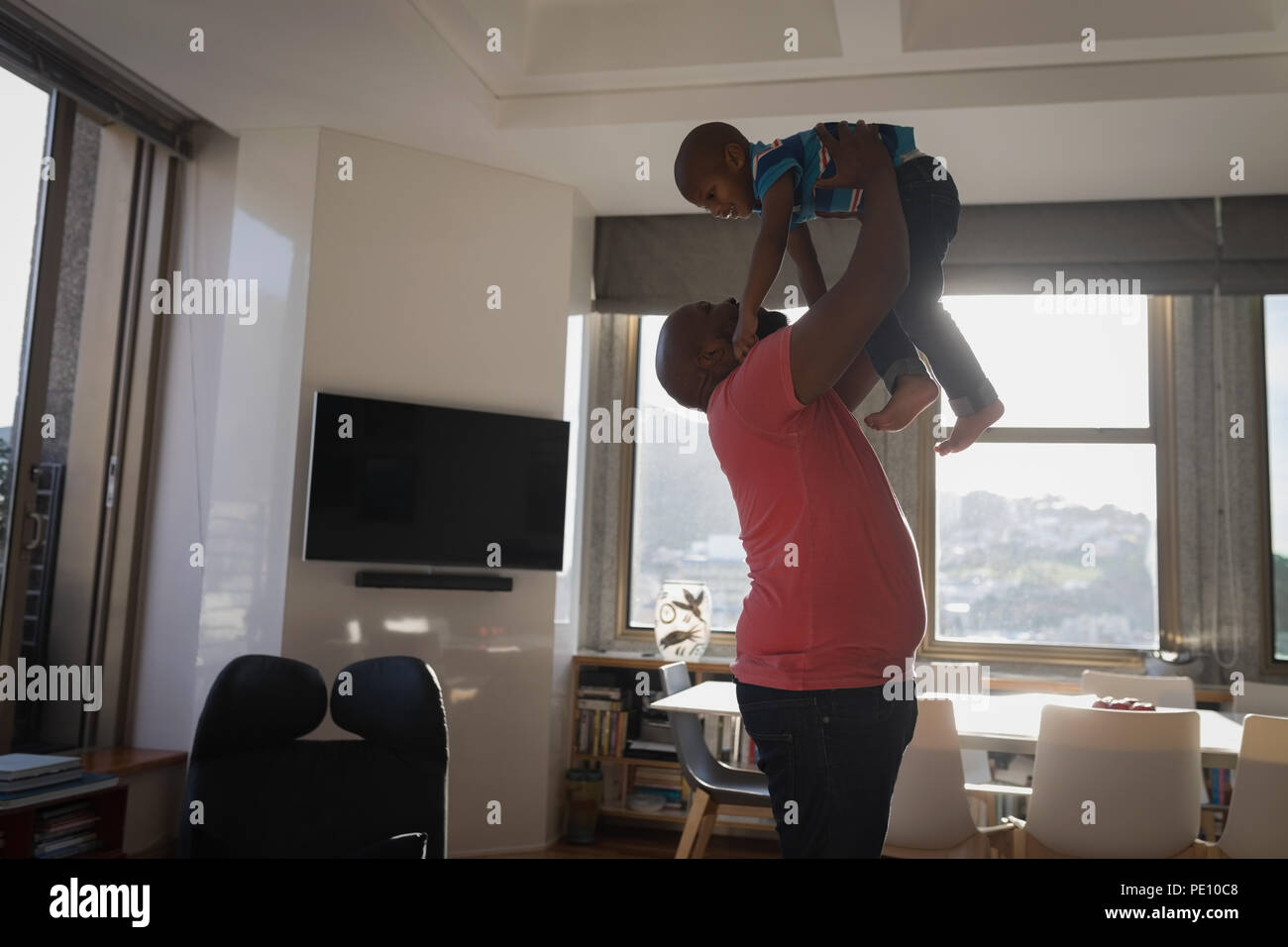 Father and son playing in living room Stock Photo - Alamy