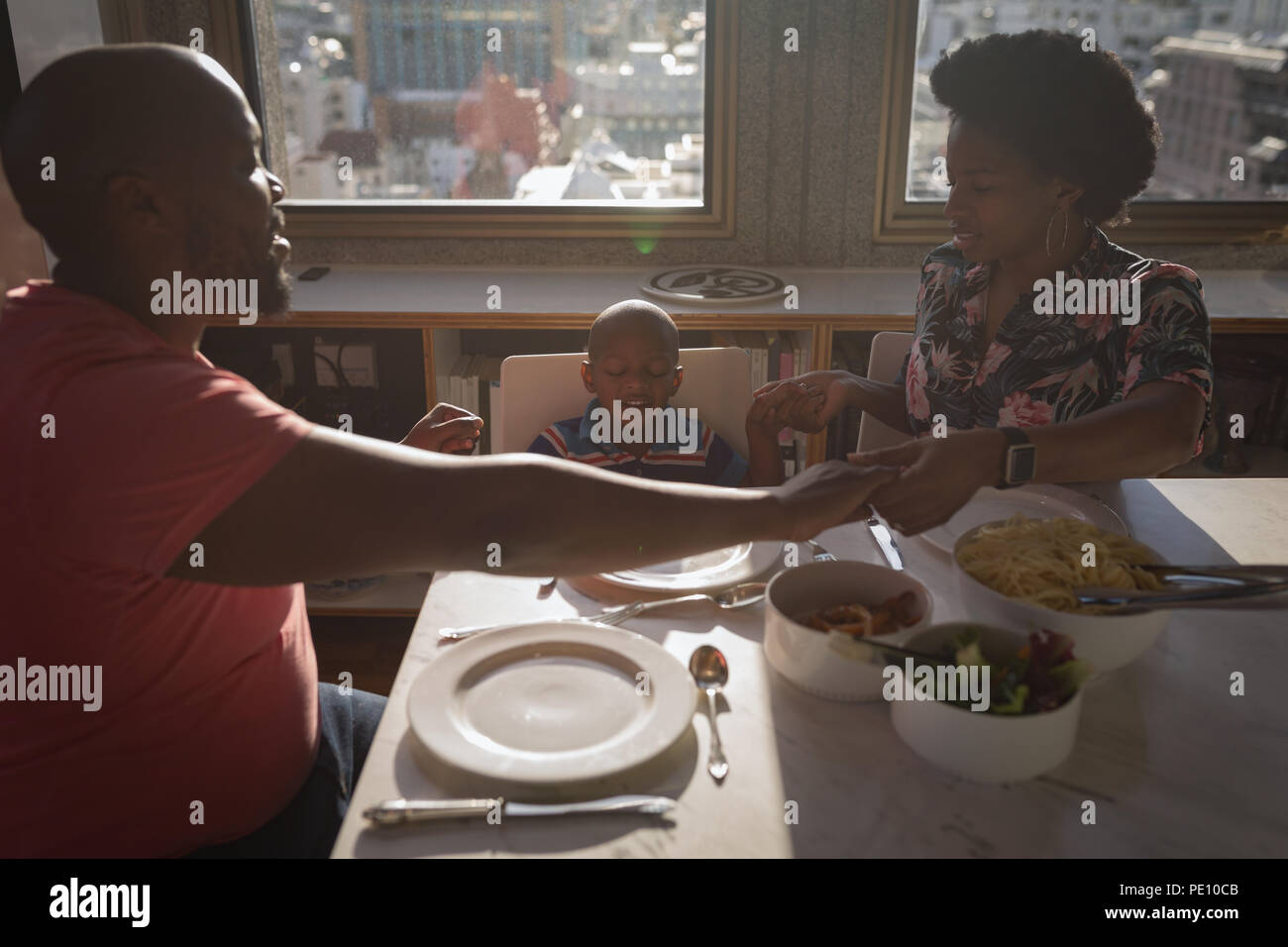 Family praying before having breakfast on dinning table Stock Photo - Alamy