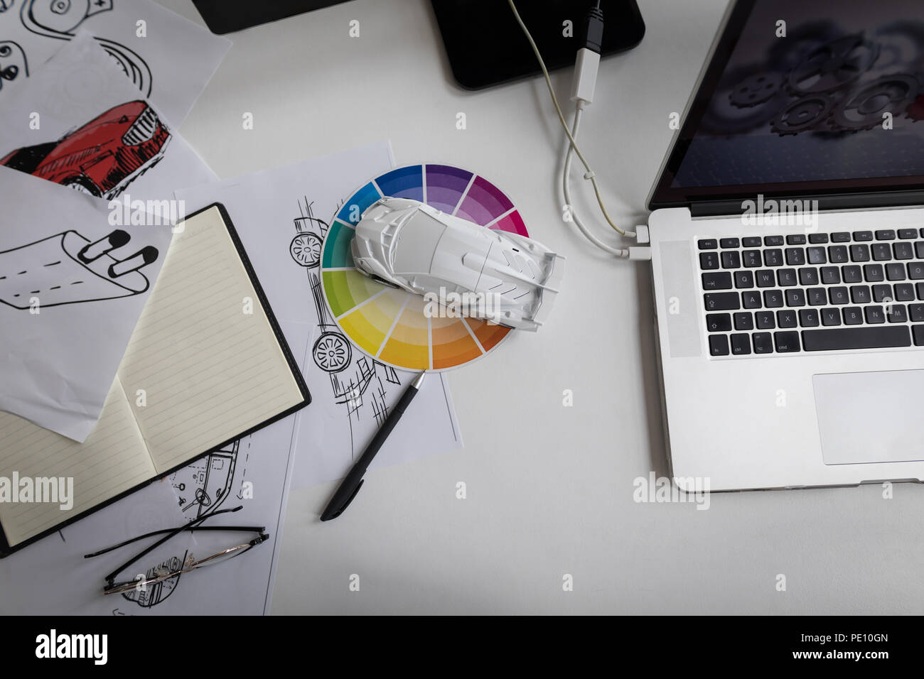 Laptop and car model on desk Stock Photo - Alamy