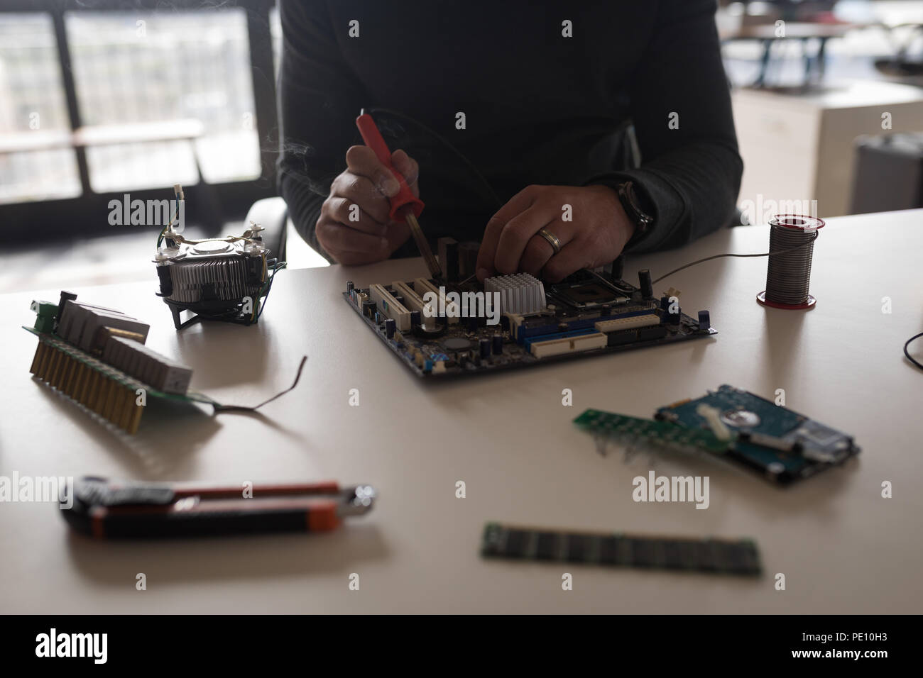 Male electrical engineer soldering a circuit board Stock Photo - Alamy