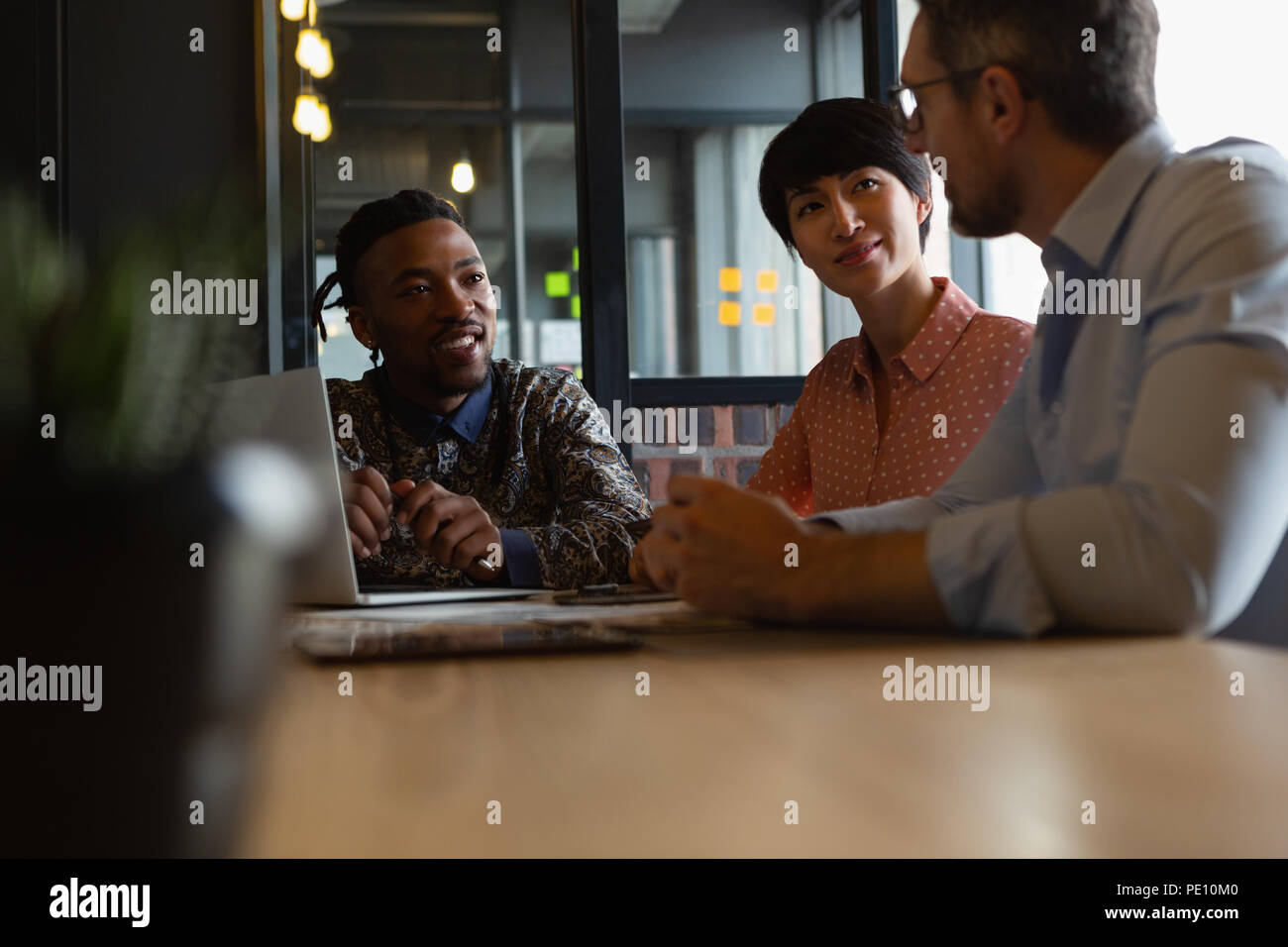 Executives discussing with each other in meeting room Stock Photo - Alamy