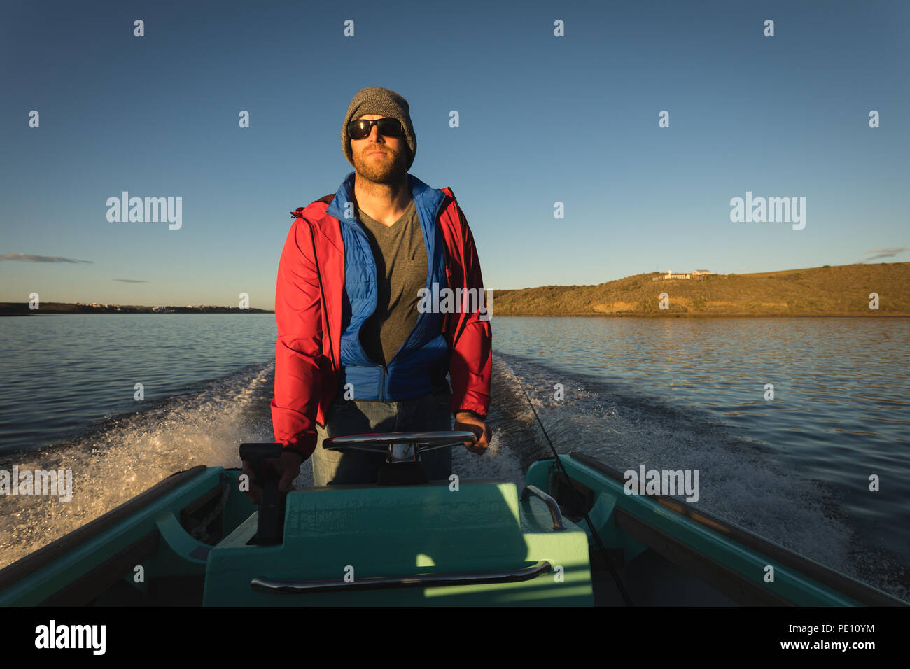 Man standing in motorboat hi-res stock photography and images - Alamy