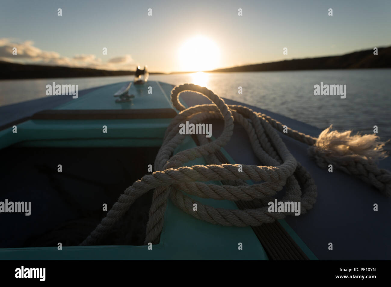 Motor boat in river at sunset Stock Photo - Alamy