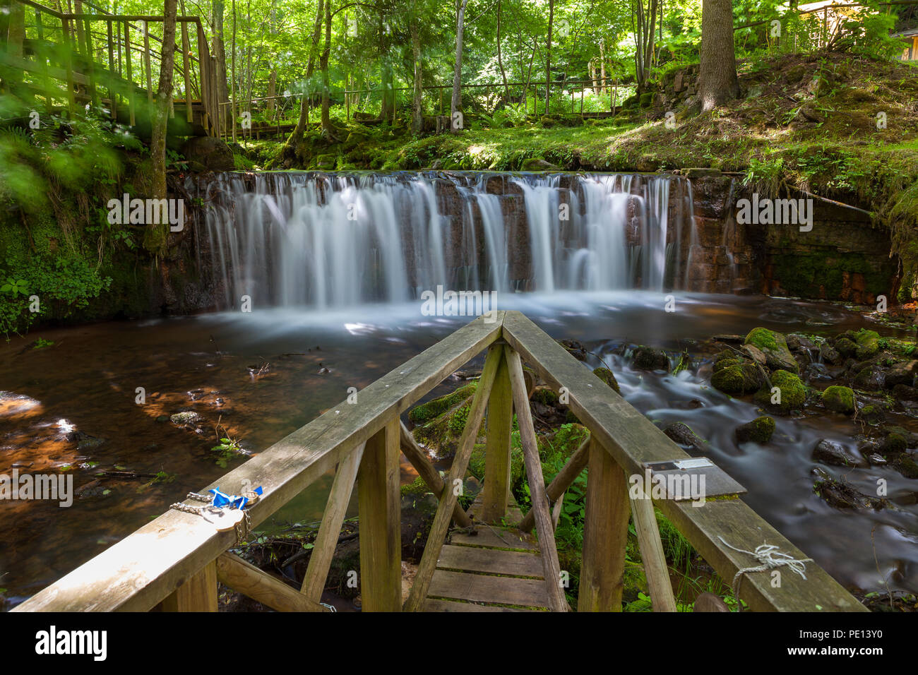 Waterfalls of Ieriku nature park at old watermill in the forest. It's a ...