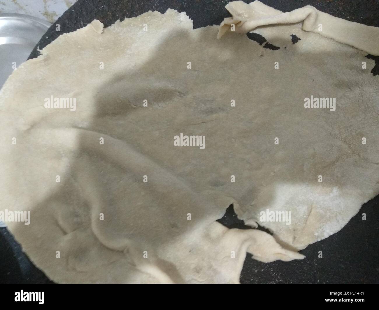 Out of shape raw flat bread chapati Stock Photo - Alamy