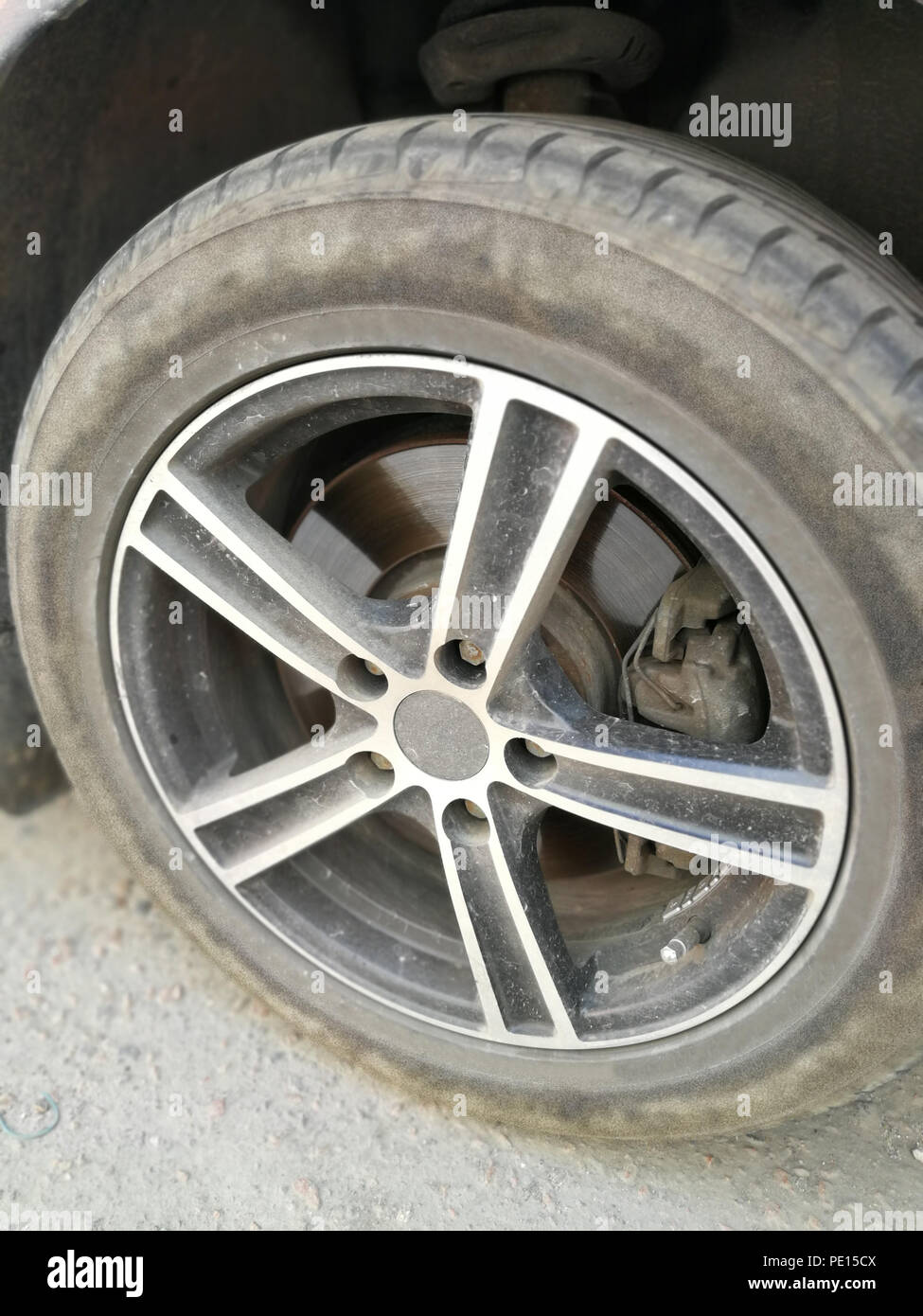 The dusty wheel of a car with a cast disk Stock Photo - Alamy