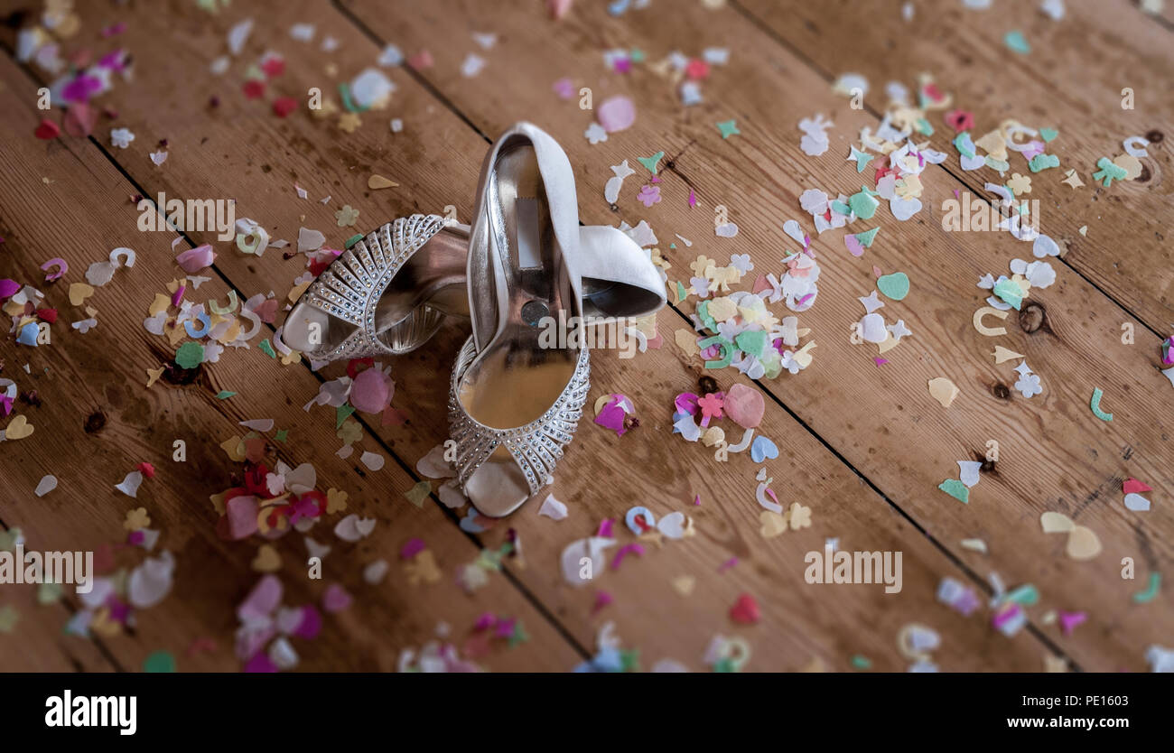Pair of Ladies Wedding Shoes on Confetti covered floor Stock Photo - Alamy
