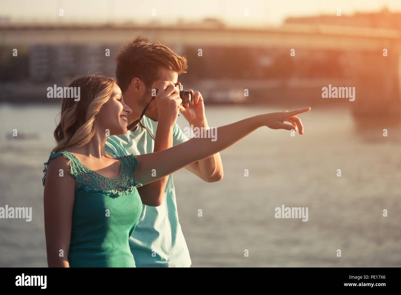 Woman photographing man by river two people hi-res stock photography ...