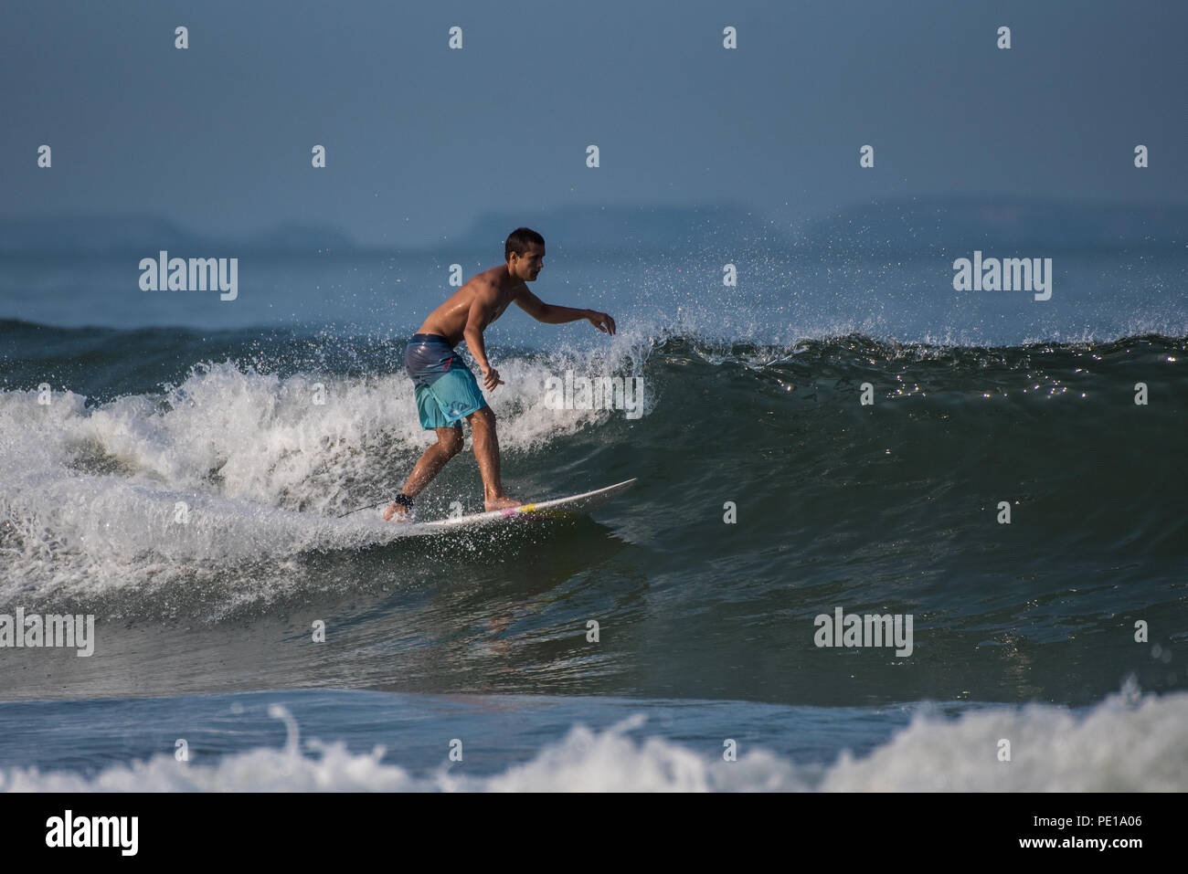 Young surfer on shortboard enjoying the summer swell on a fun left ...