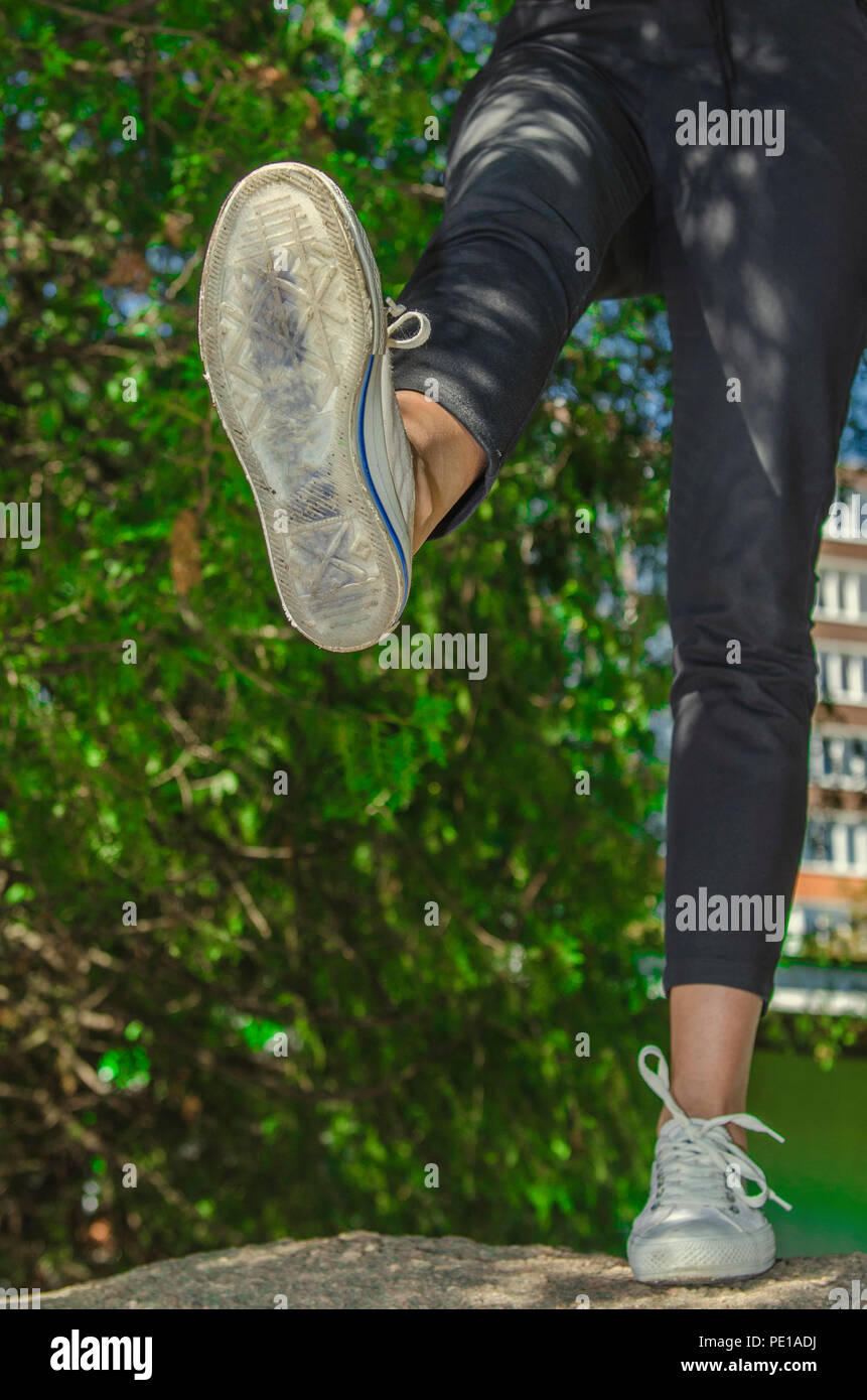 female foot in white sneakers takes a step forward Stock Photo - Alamy