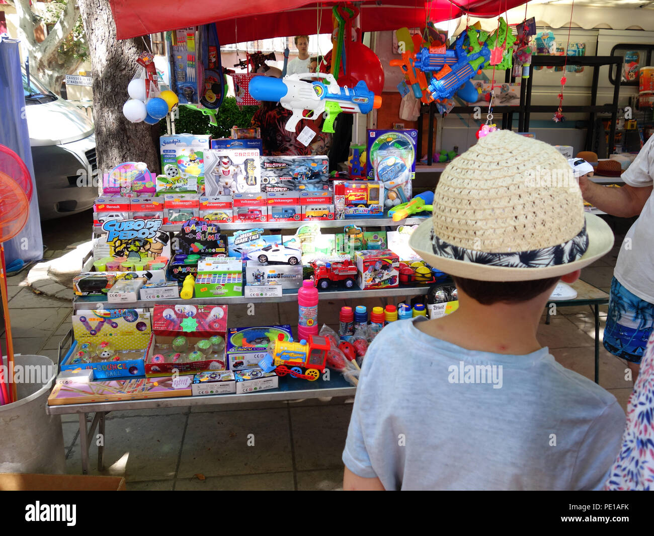 A young child and a lady photographed from the back looking at the Toy ...