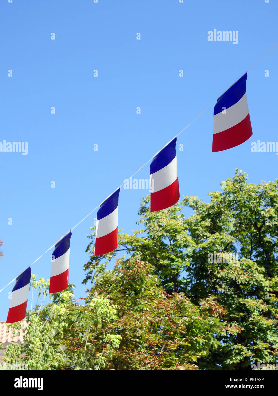 French String Flag Banners in rows floating in a summer blue sky in ...