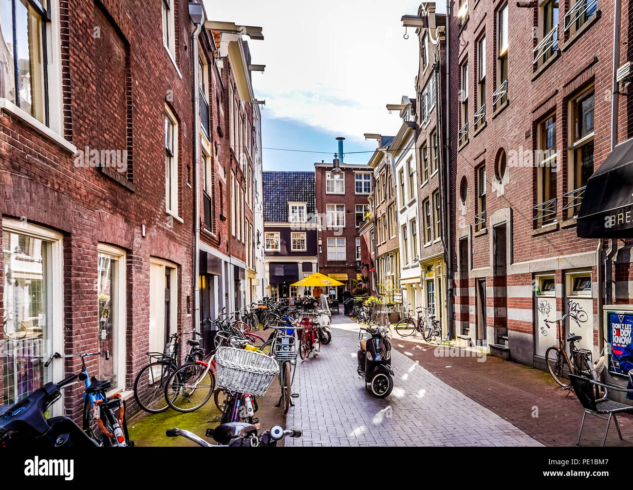 Typical Alley lined with bikes along the historic houses in the old ...