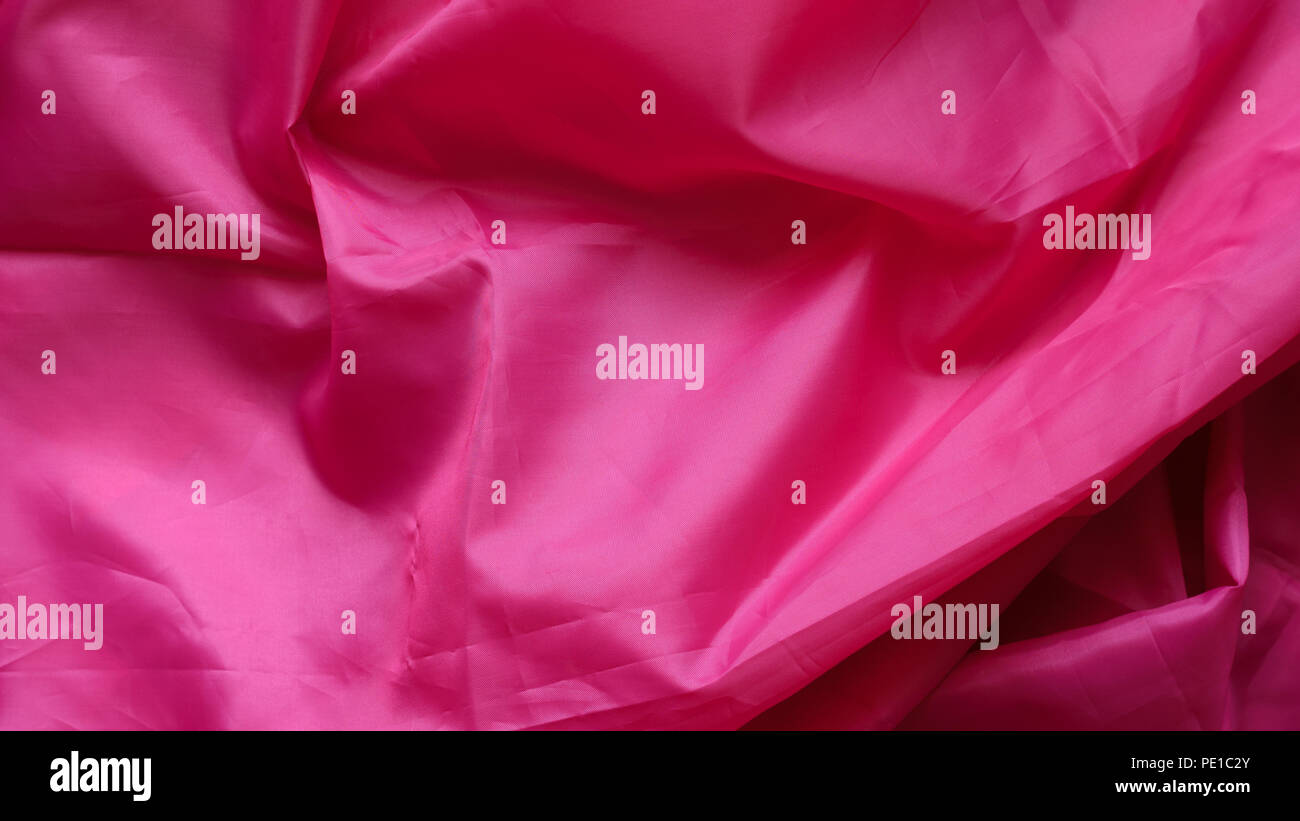 Pink Synthetic Lining Fabric with Folds. Crumpled Sheet or Clothes ...