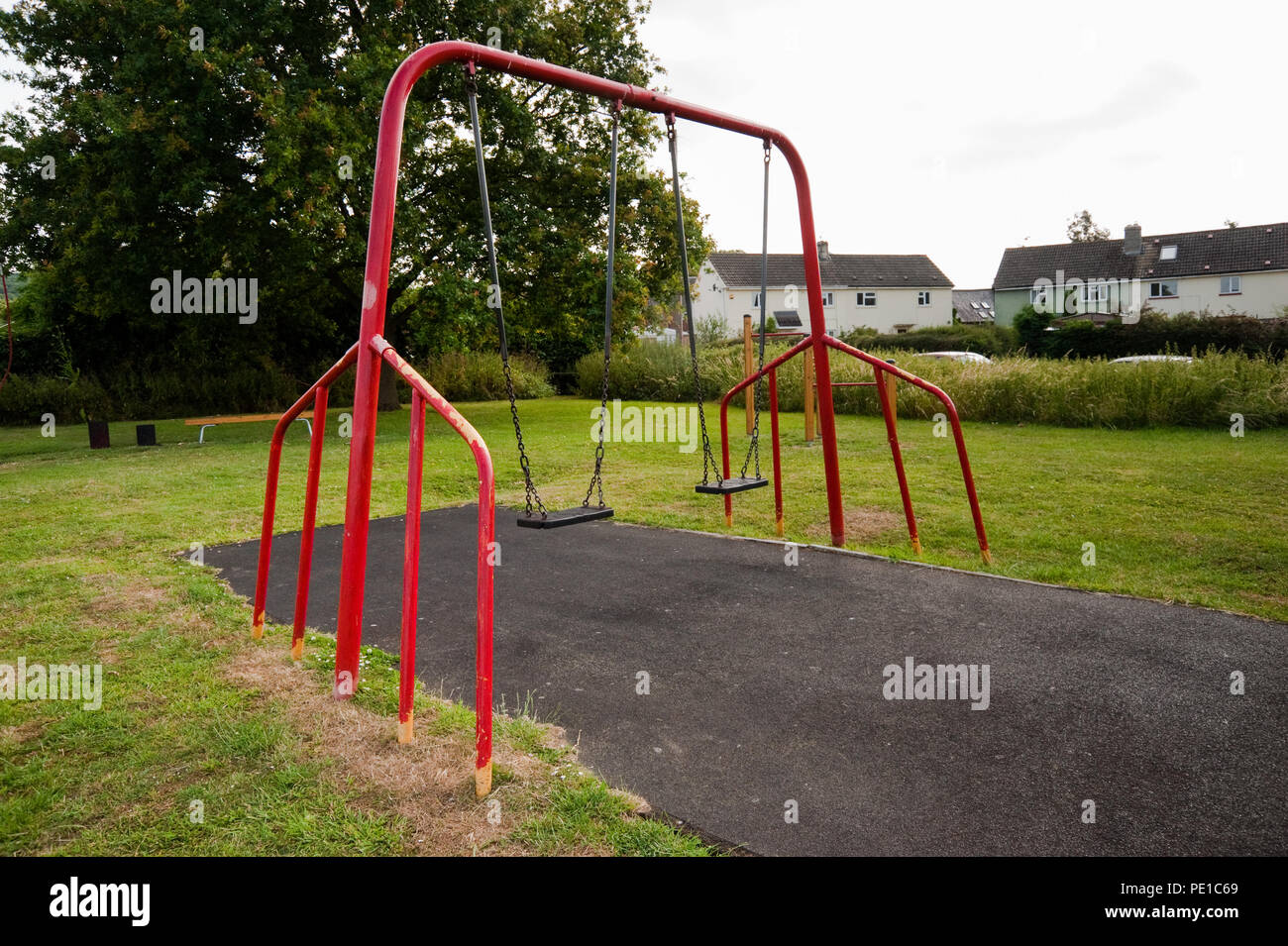 Swings on a playground Stock Photo - Alamy