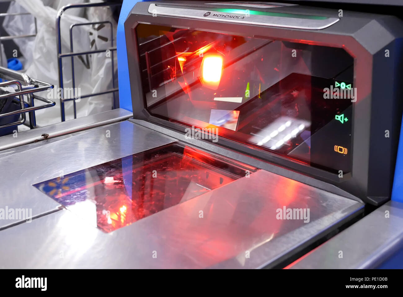 Motion of scanning machine flashing red light at self-check out counter ...