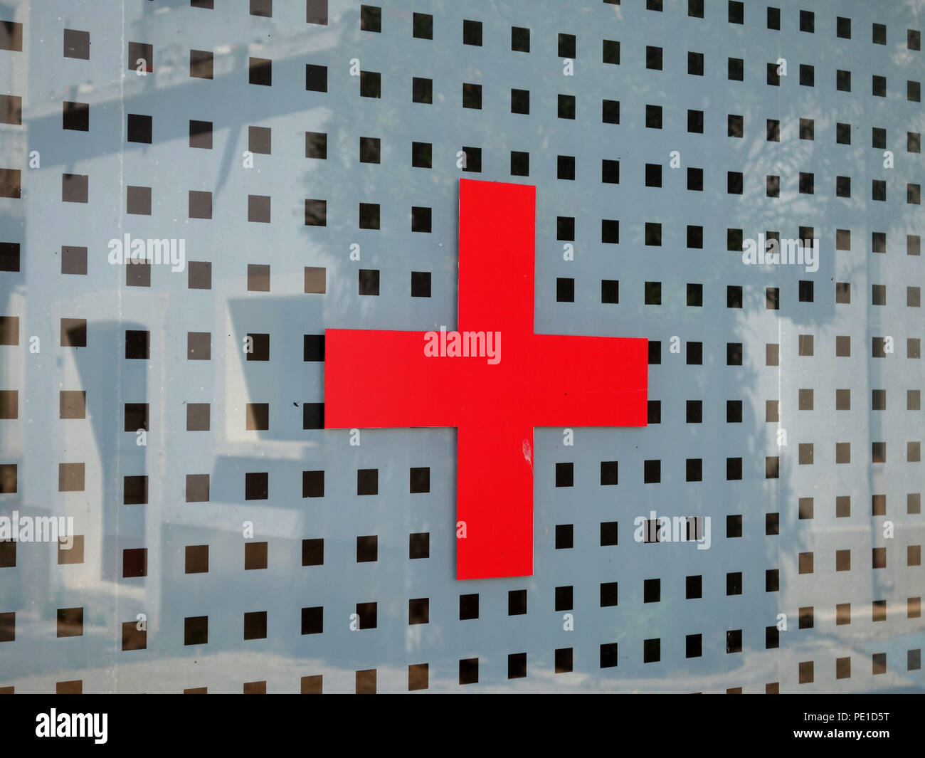 Red Cross on window of Doctors surgery and Medical office in Cessenon ...