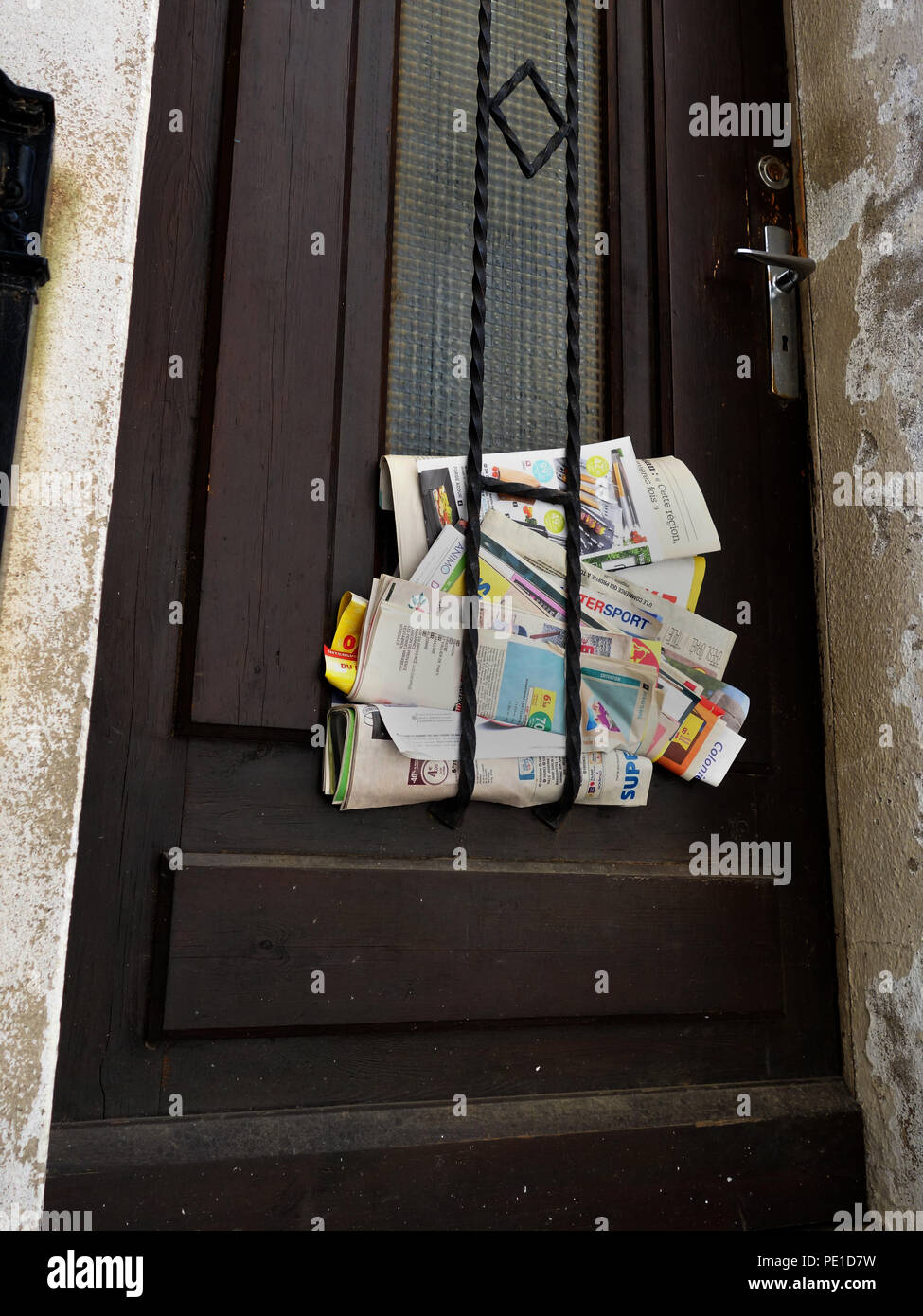 Junk mail left wedged in door of a house in Cessenon-sur-Orb, France ...