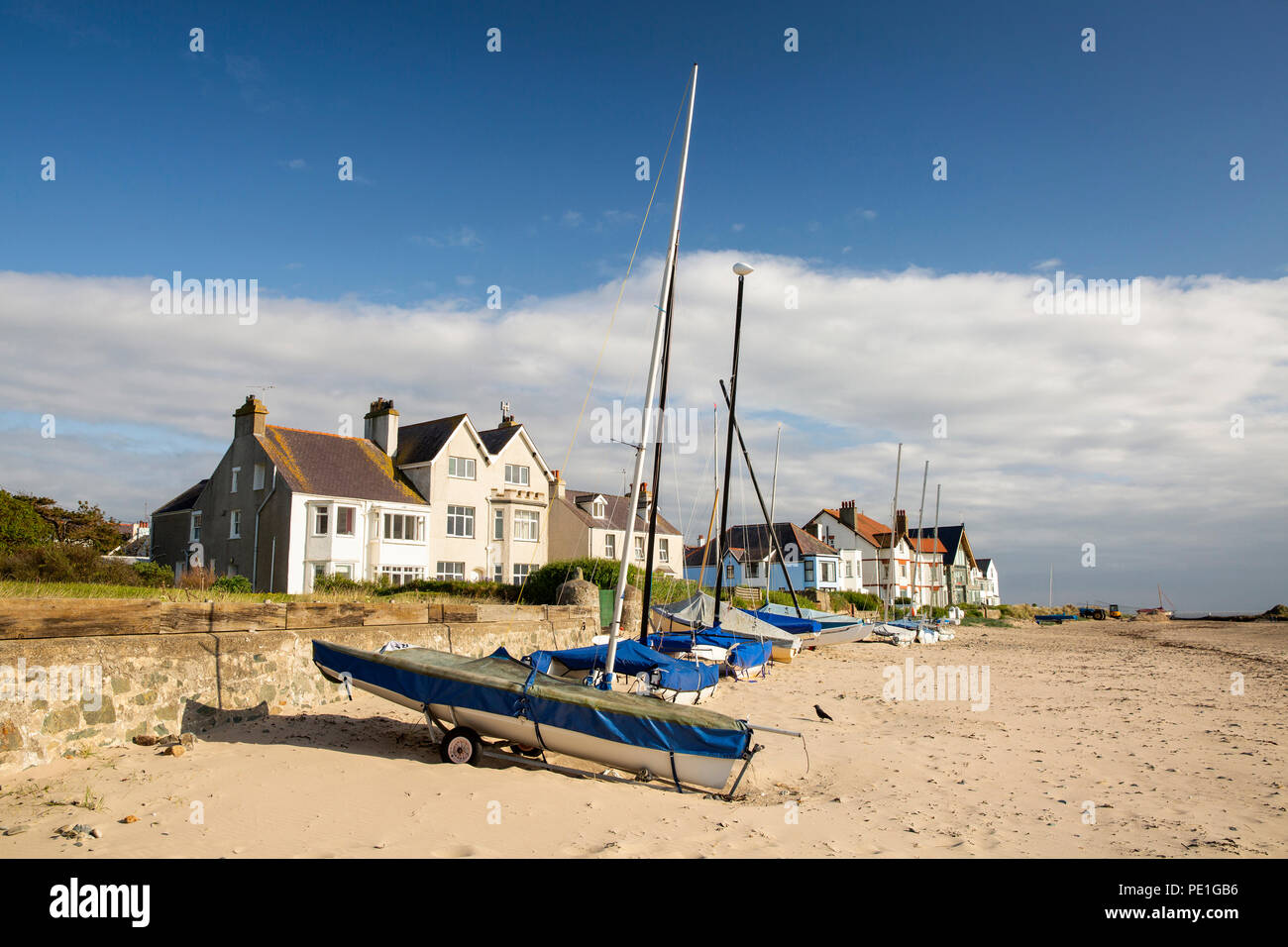 UK, Wales, Anglesey, Rhosneigr, boats on beach at seafront houses Stock ...