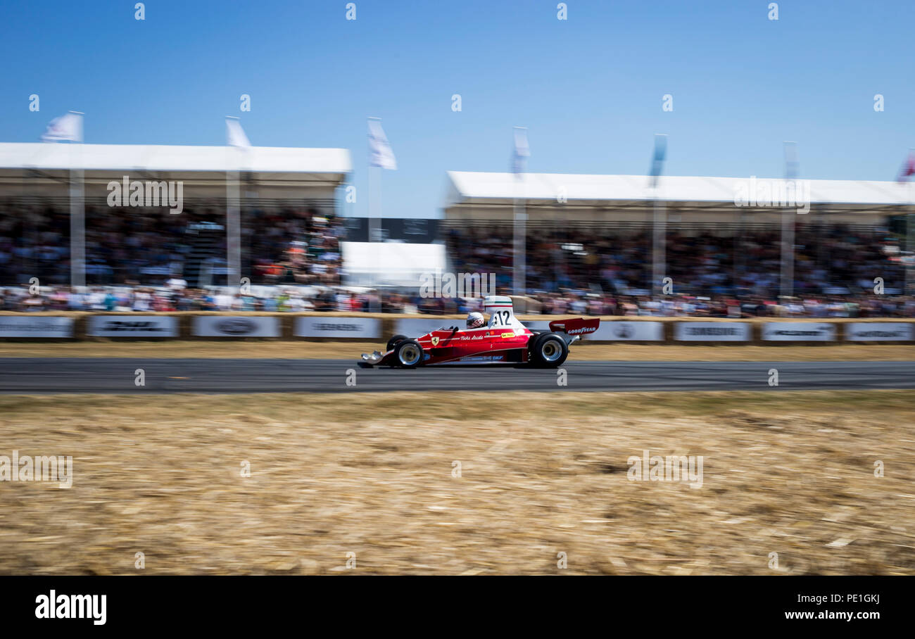 A Ferrari Formula One car speeds past a grandstand on the hillclimb at ...