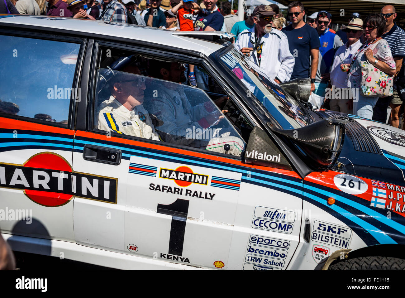 A rally car returning to the paddock through a crowd at the Goodwood ...