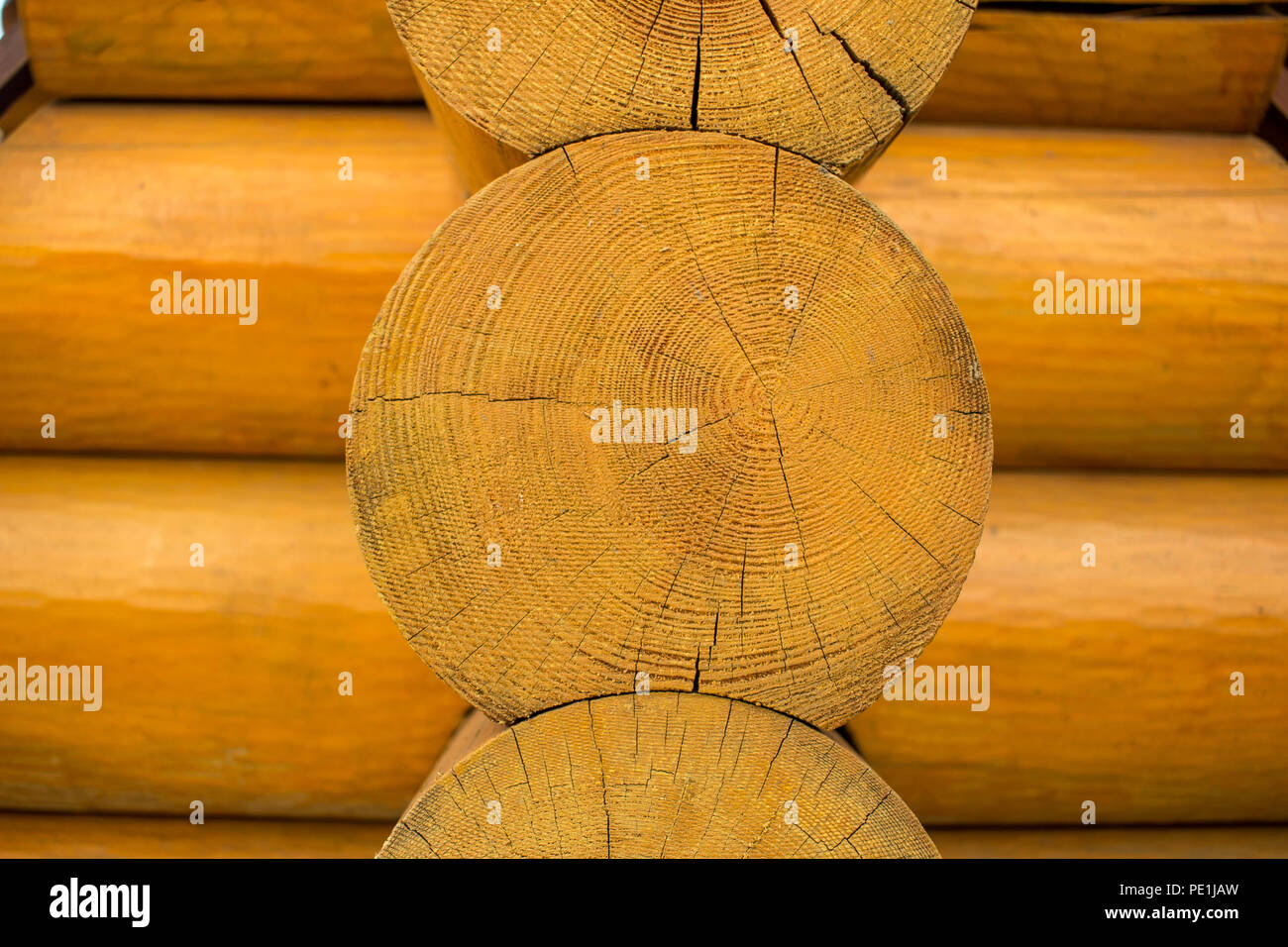Round orange logs on wooden house Stock Photo - Alamy