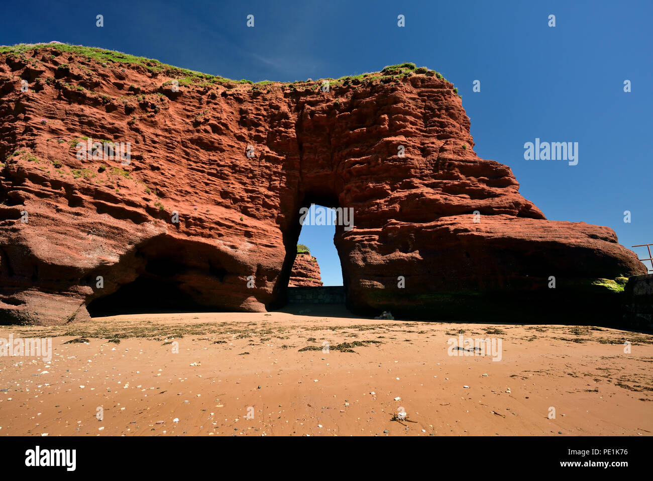A natural arch in Langstone Rock Stock Photo - Alamy