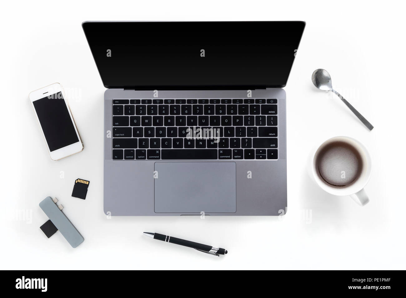 Top view of tabletop with laptop, mobile phone, memory cards, card ...