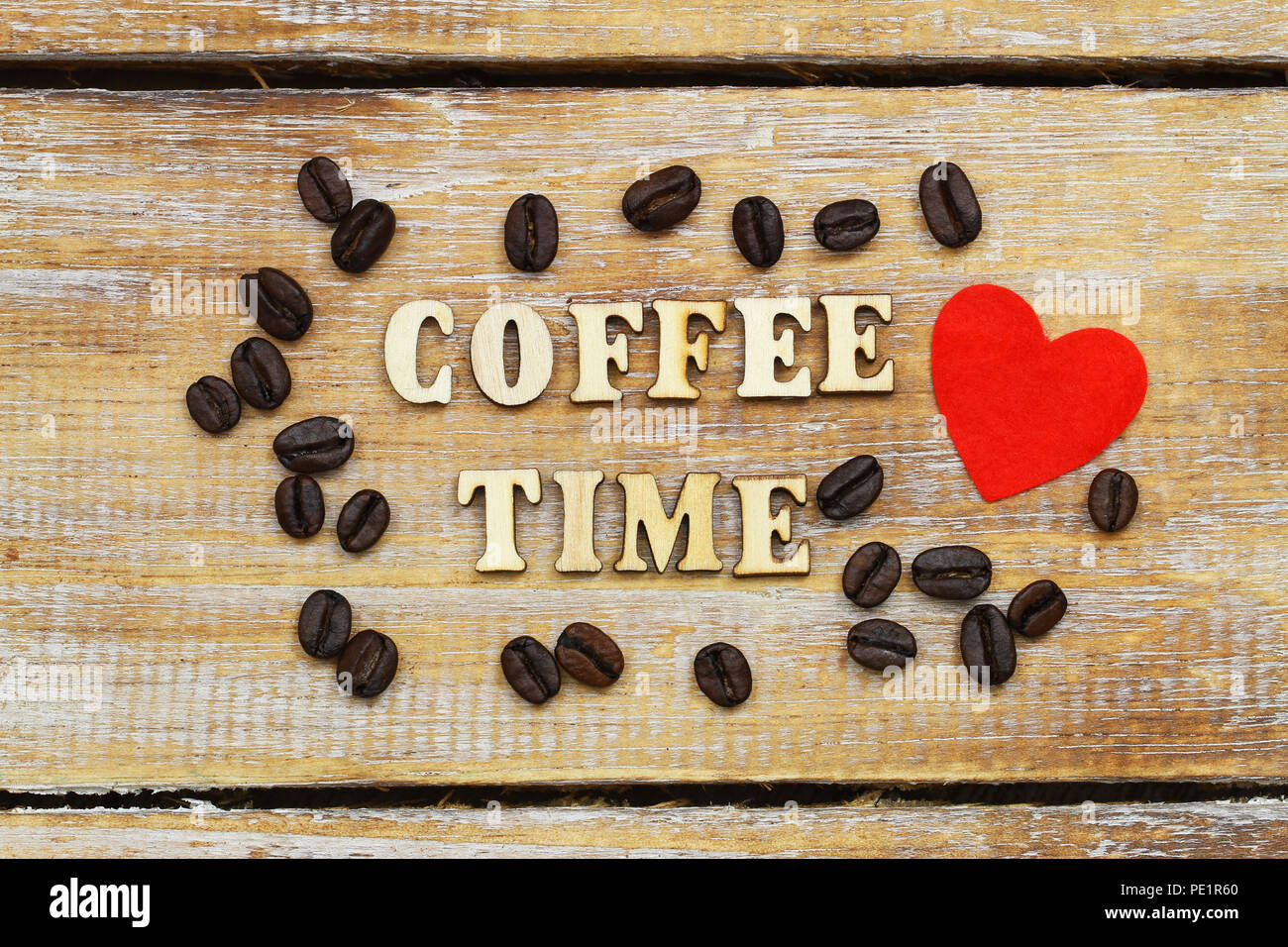 Coffee time written with wooden letters on rustic surface, red heart ...
