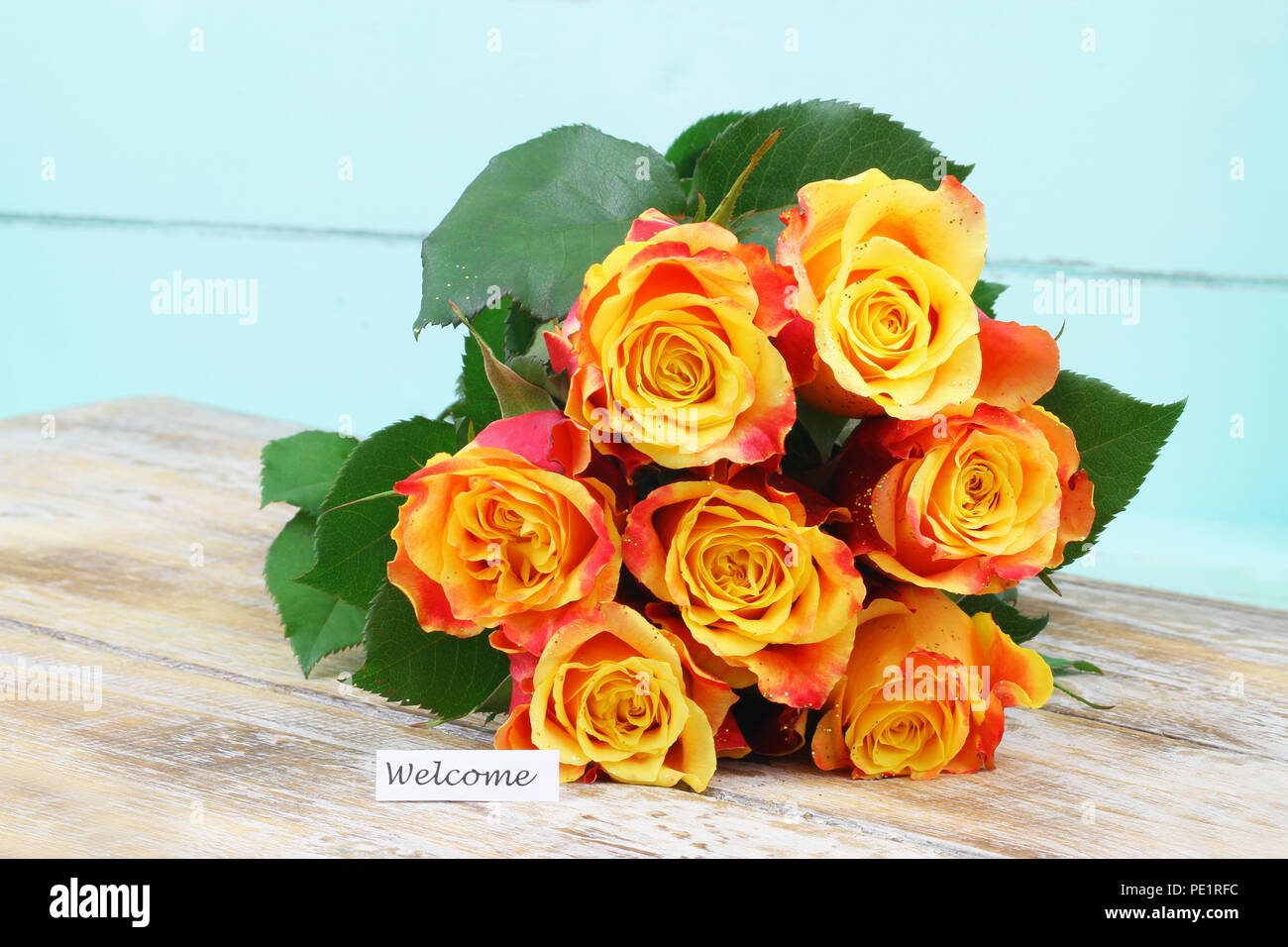 Welcome card with orange rose bouquet on wooden surface Stock Photo - Alamy