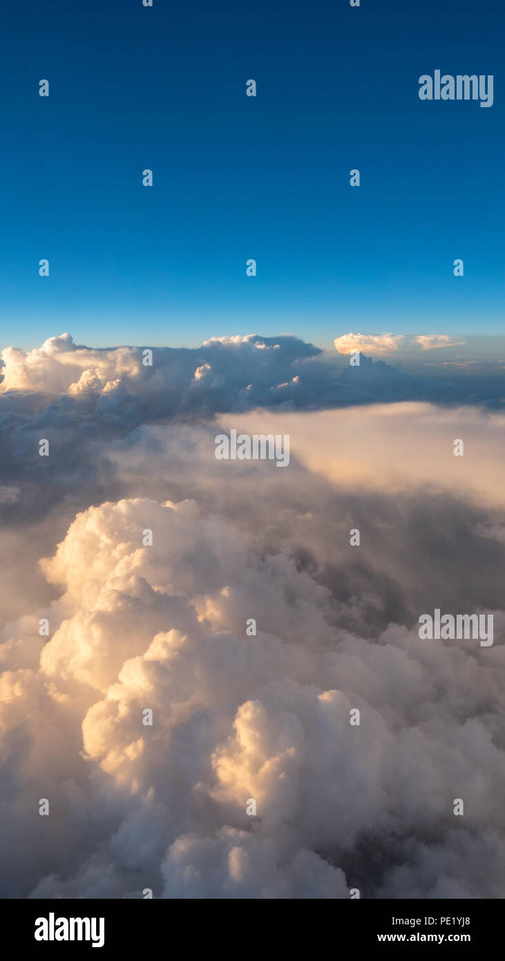 Portrait View of Sunset Light Reflected on Large Clouds from Airplane ...