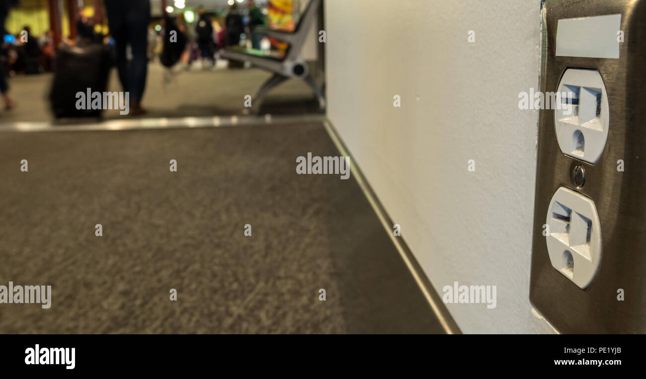 Close up View of Wall Outlet with Travelers in the Background Stock ...