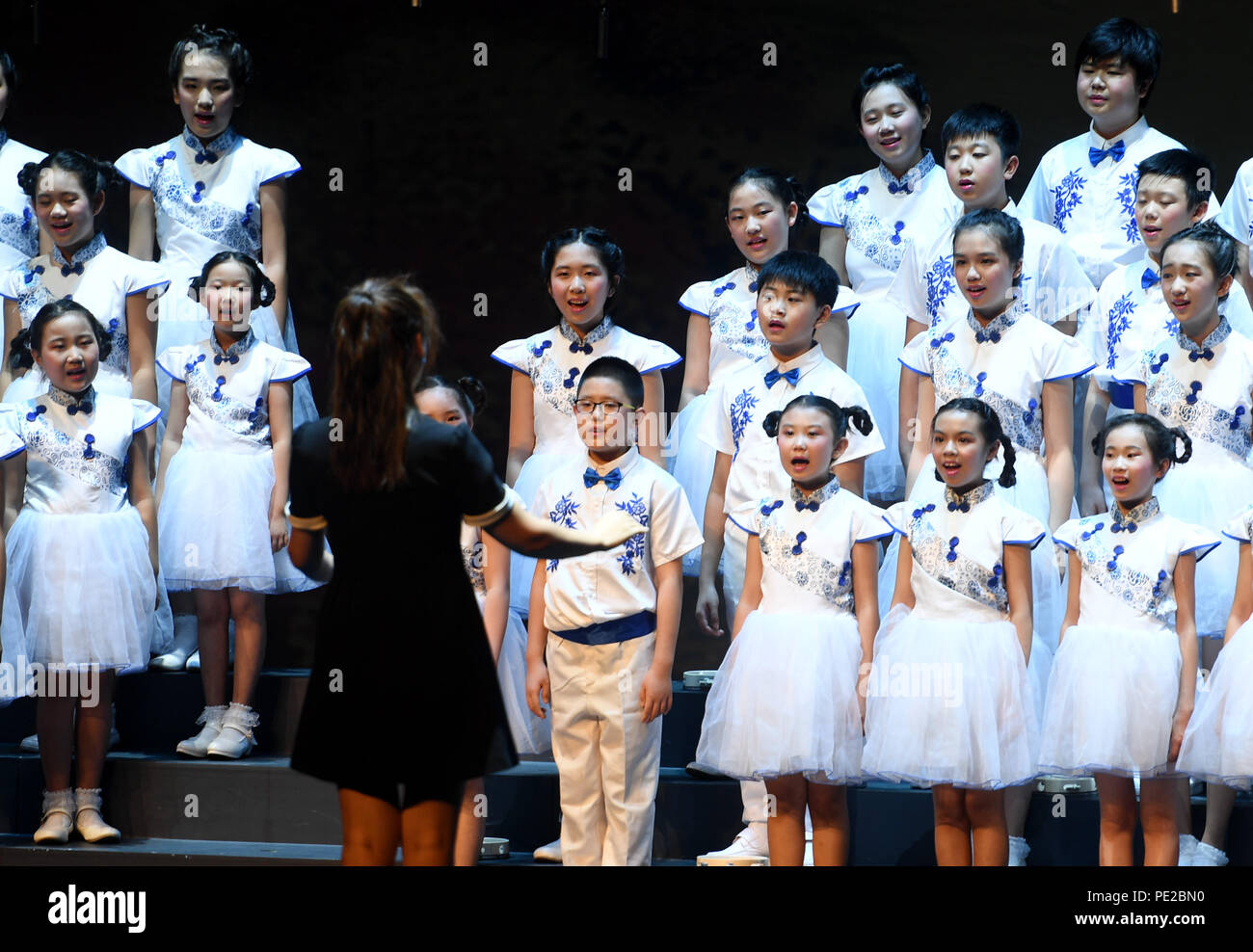 Beijing, China. 12th Aug, 2018. Children sing poems during a public ...
