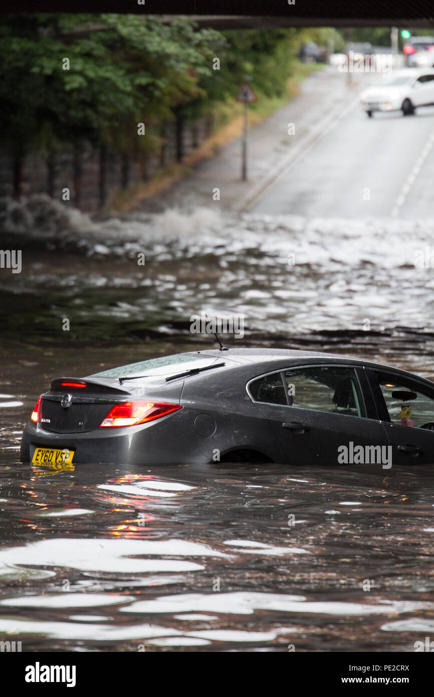 Liverpool, UK. 12th August, 2018. UK Weather. Young couple are trapped ...