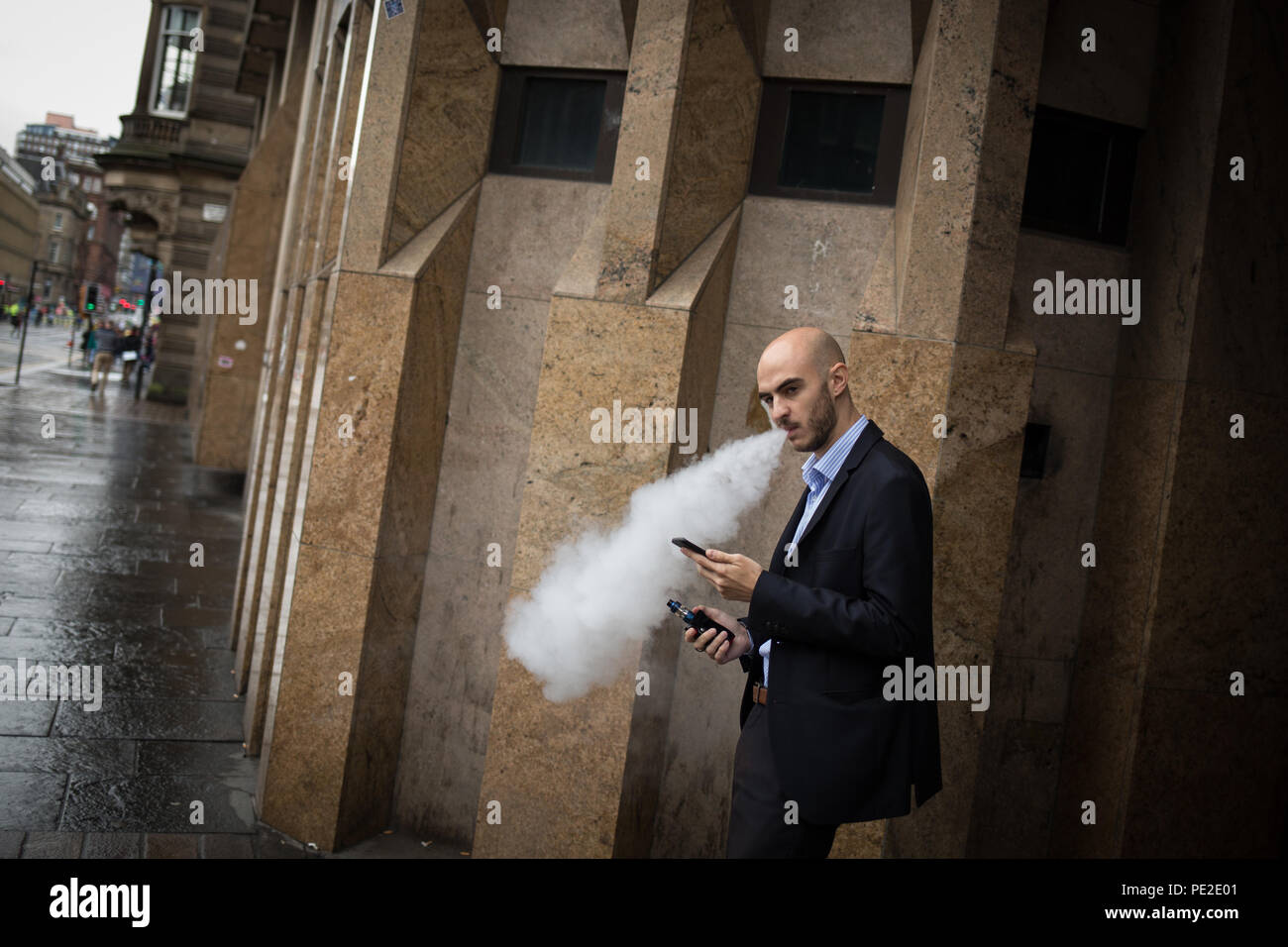 Man vaping in street hi-res stock photography and images - Alamy