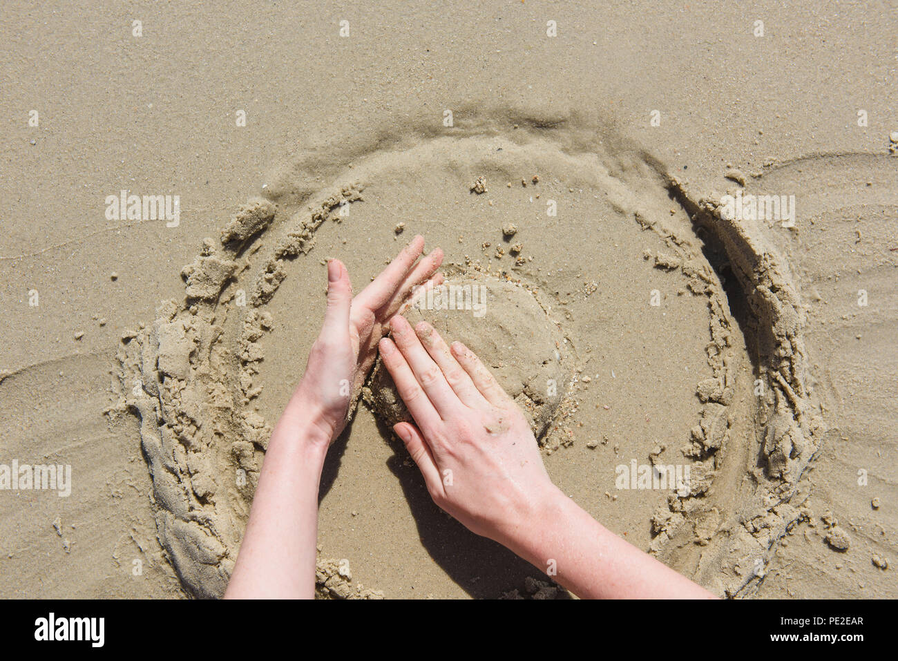 women's hands do a sand castle on the beach. view from above Stock ...
