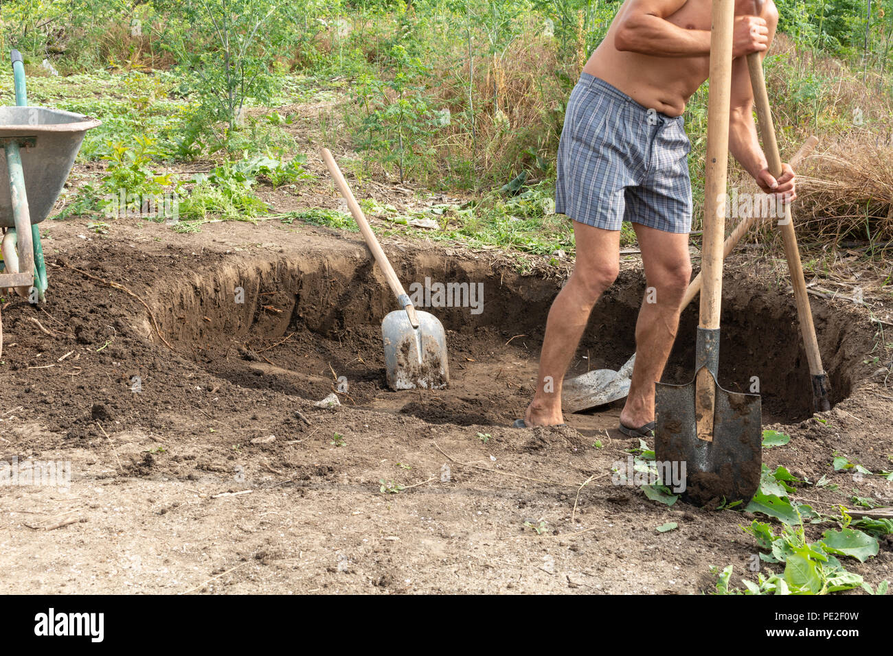 Workers dig a pit for a septic tank in a private house Stock Photo - Alamy